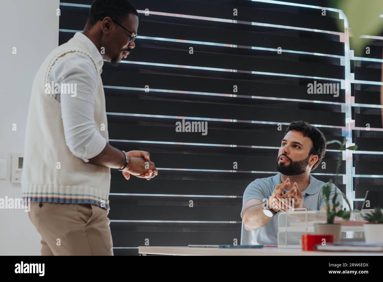 A diverse team of professionals collaborates in a modern office, using ...