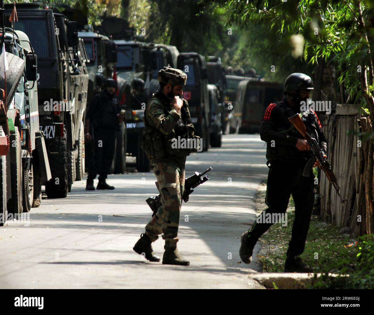 Indian army soldiers stand near the site of gun-battle between ...