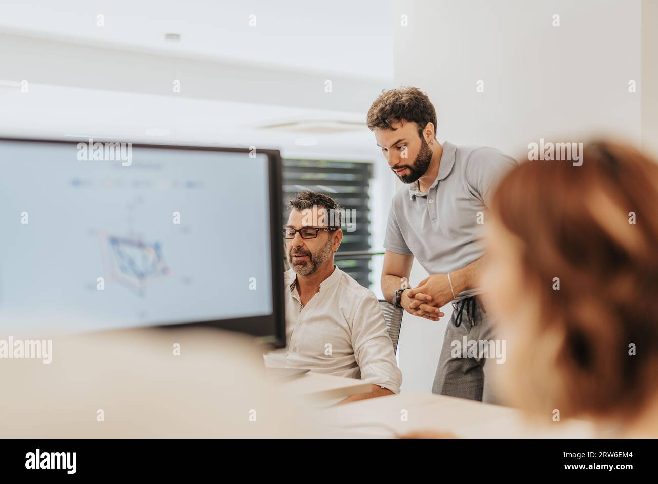 In this dynamic office environment, a group of colleagues collaborates ...