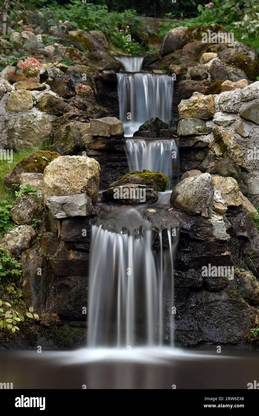 Triple level waterfall in long exposure, in vertical format Stock Photo ...