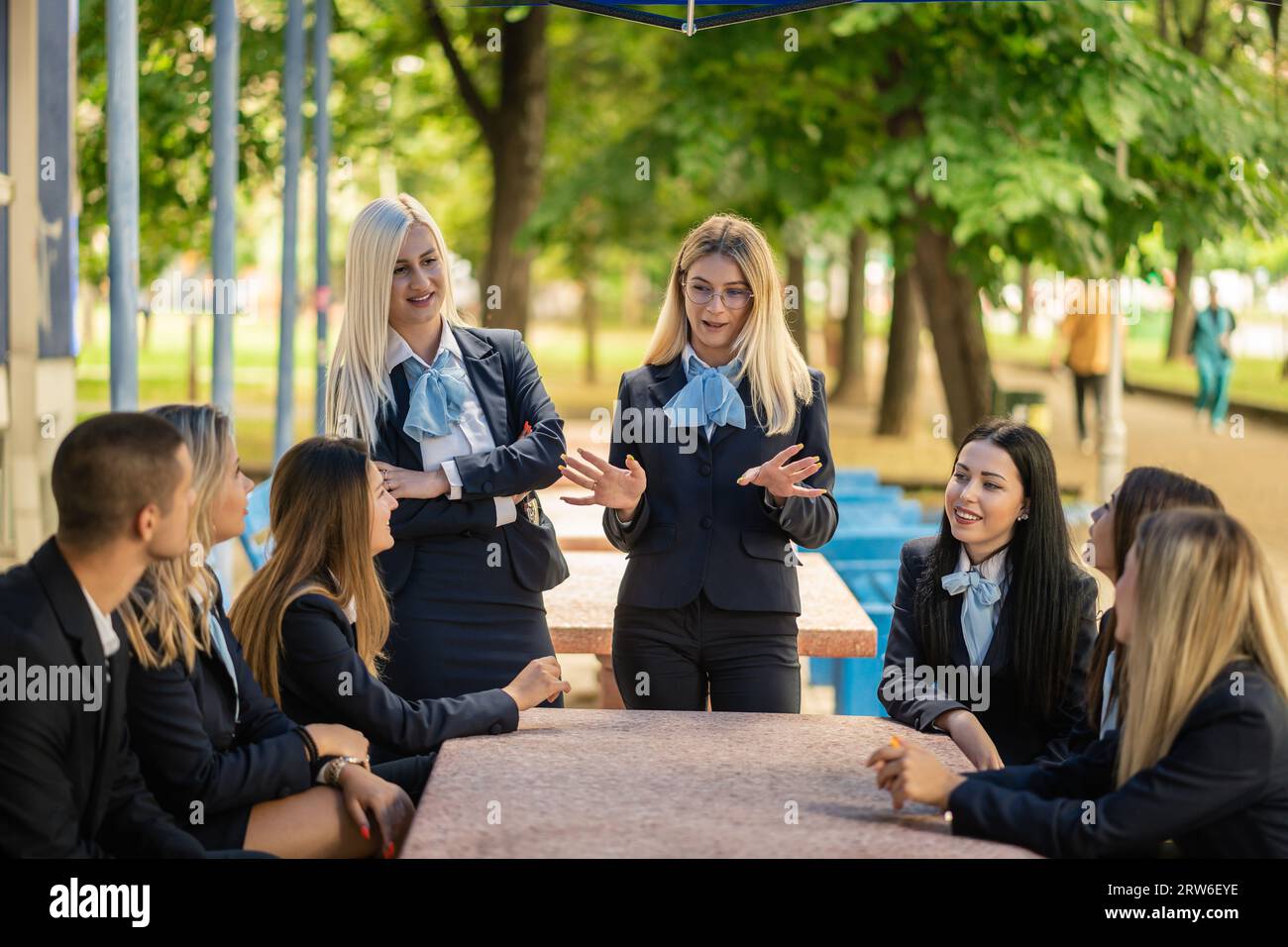 College students discussing subjects before exams at the school yard ...