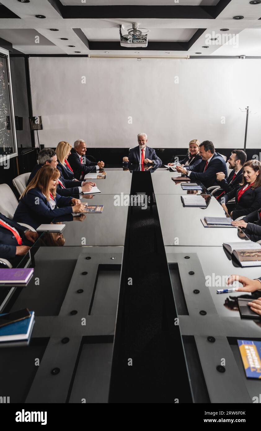 Business leaders, directors, and executives gather in a modern office ...