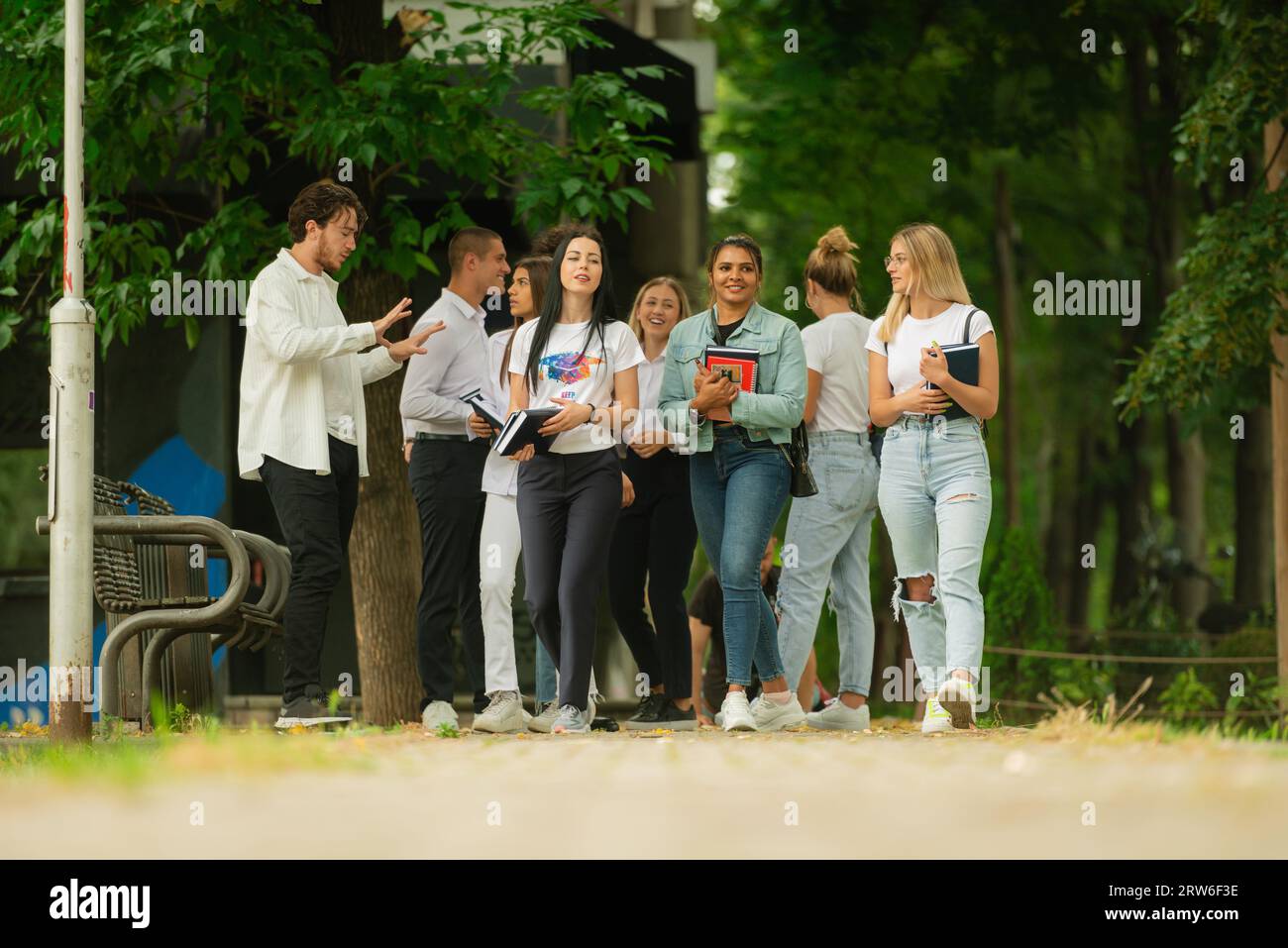 Young high school classmates standing together in a circle studying and ...