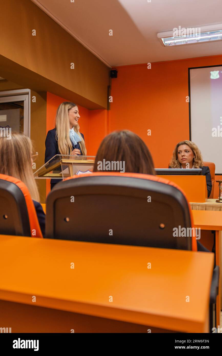 Conference room full of young students and old professors applauding ...