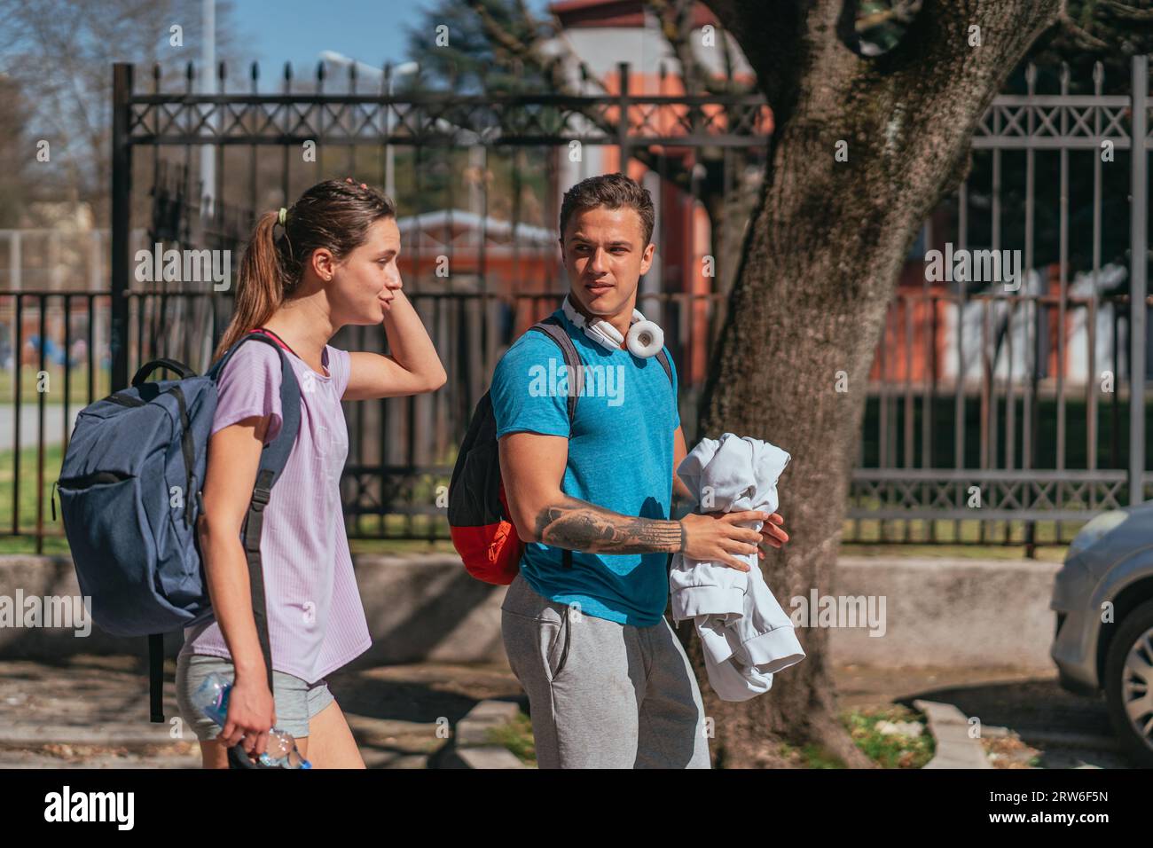 Handsome male person listening to her female friend complaining how big ...