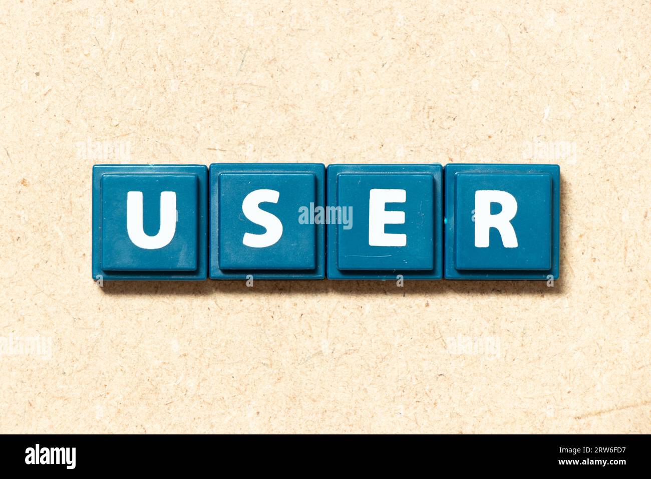 Tile alphabet letter in word user on wood background Stock Photo - Alamy