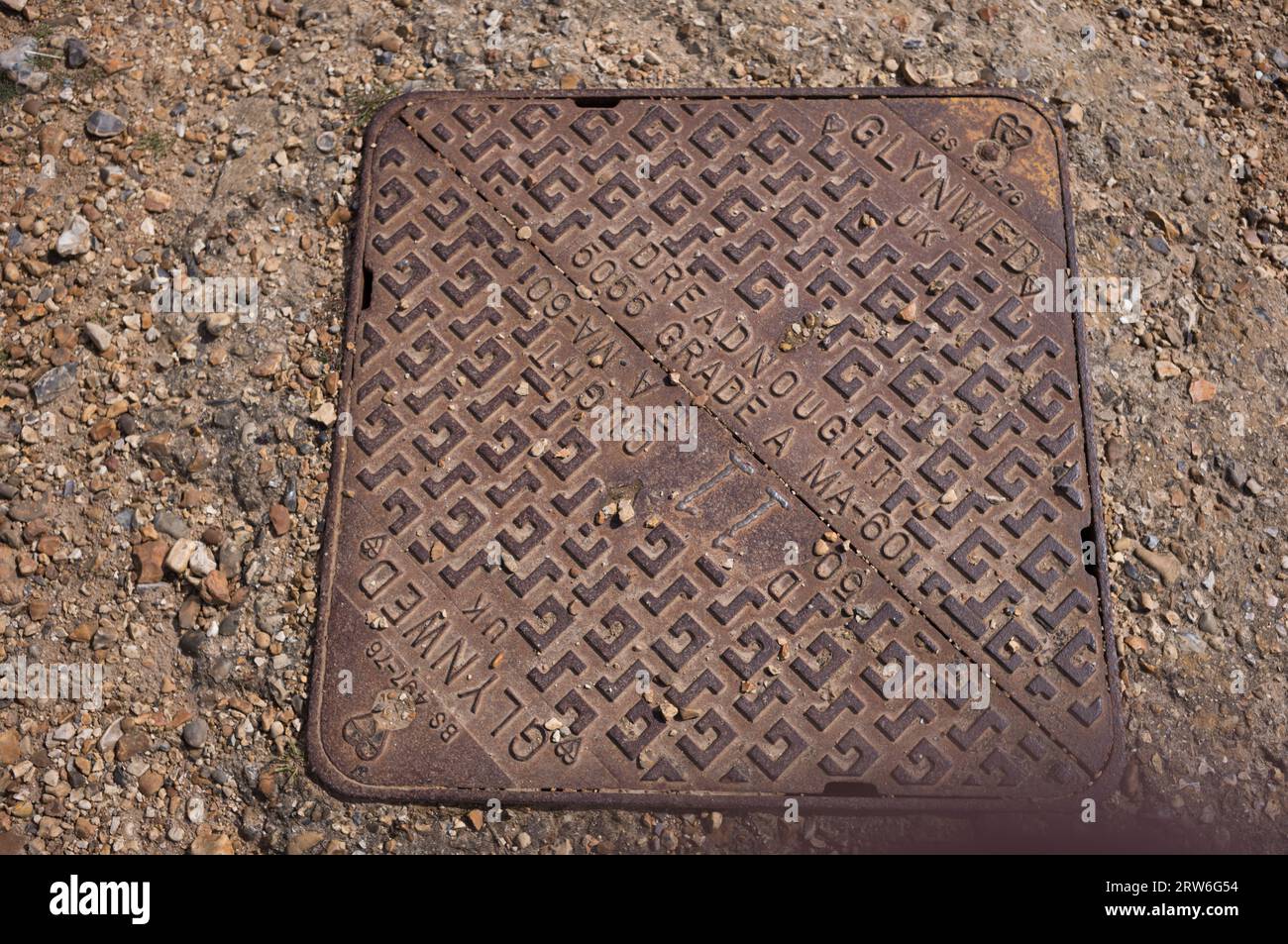 Dreadnought manhole cover set in a sandy path Stock Photo - Alamy