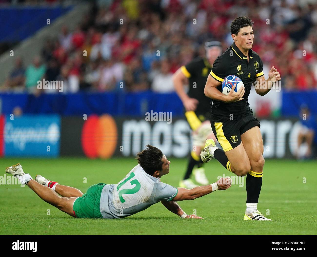 Wales' Louis Rees-Zammit (right) evades Portugal's Tomas Appleton ...