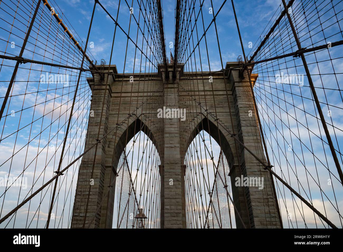 The structural elements of the Brooklyn bridge, steel cables and stone ...