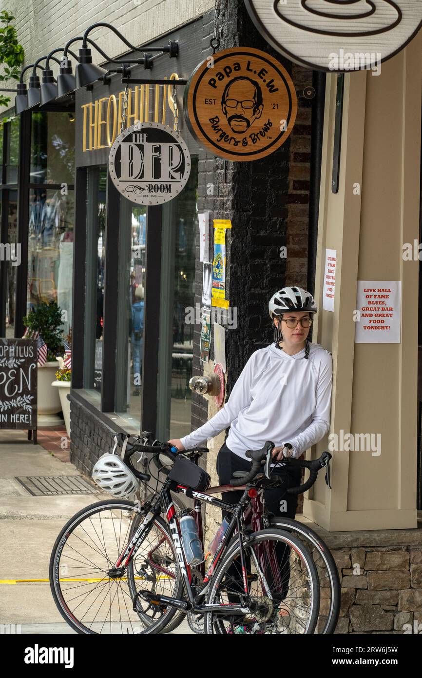 Cyclist resting against the wall on sidewalk Stock Photo - Alamy