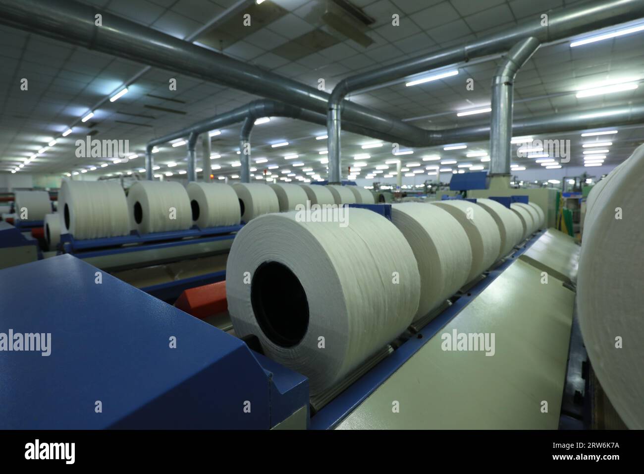 The cotton yarn on the production line is in a spinning factory Stock ...