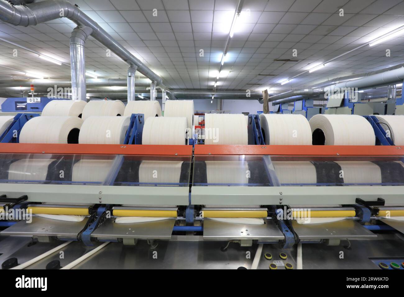 The cotton yarn on the production line is in a spinning factory Stock ...