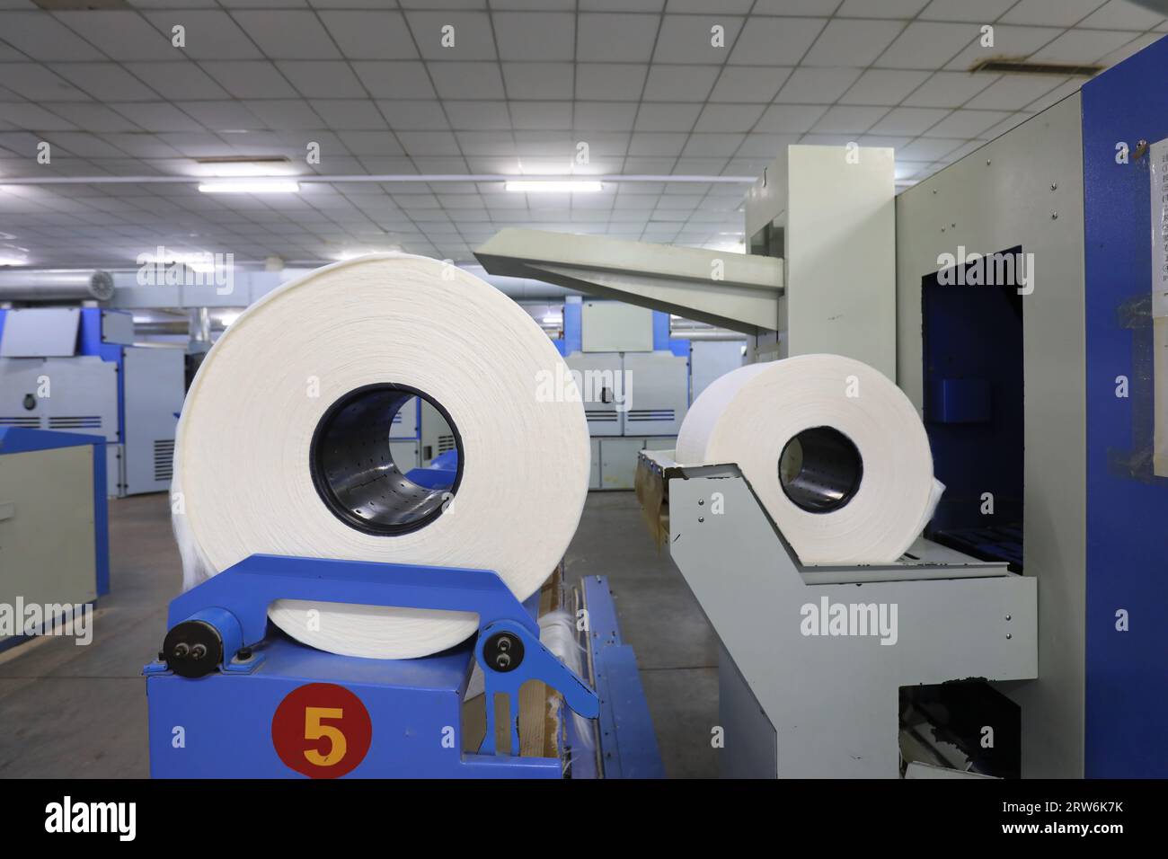 The cotton yarn on the production line is in a spinning factory Stock ...
