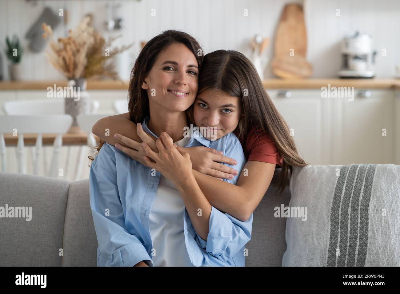 Mother-daughter connection. Cute girl child cuddling smiling mom ...