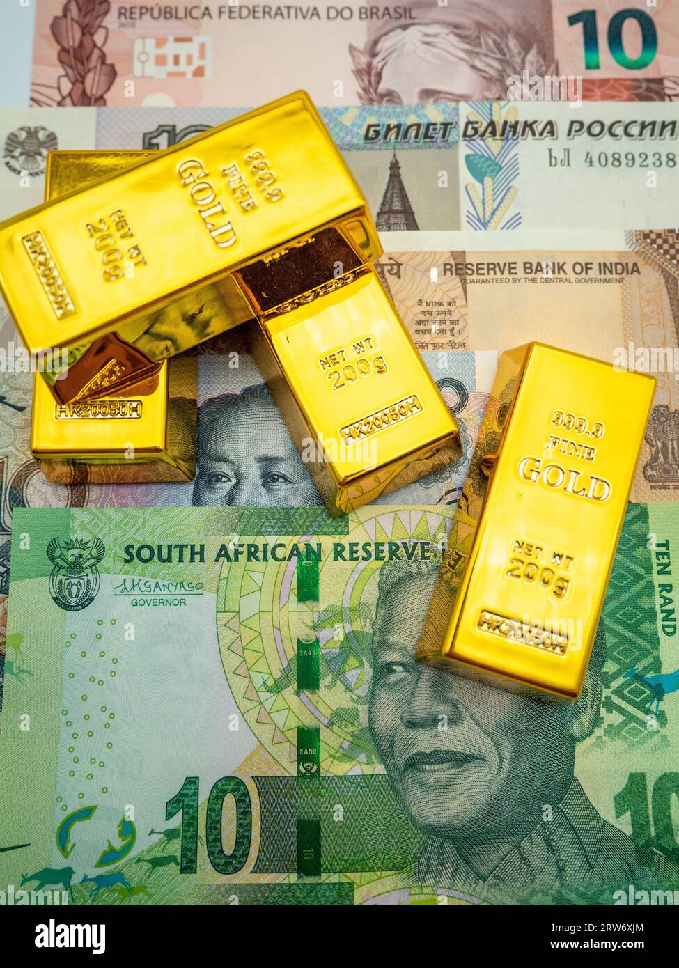 The golden bars on the surface with different currency banknotes Stock ...