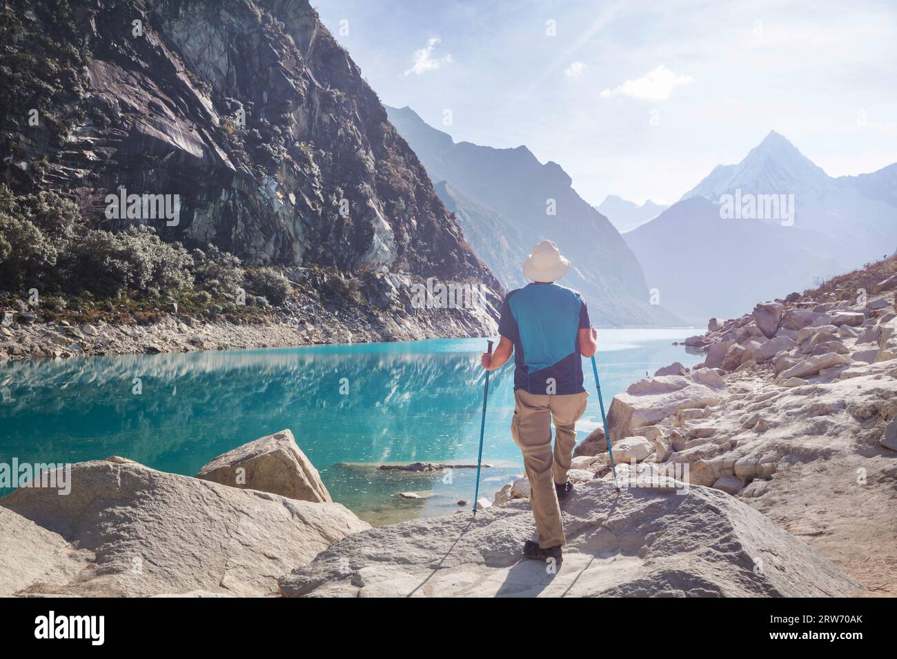 Hiker admires the lake Paron in Cordillera Blanca, Peru, South America ...