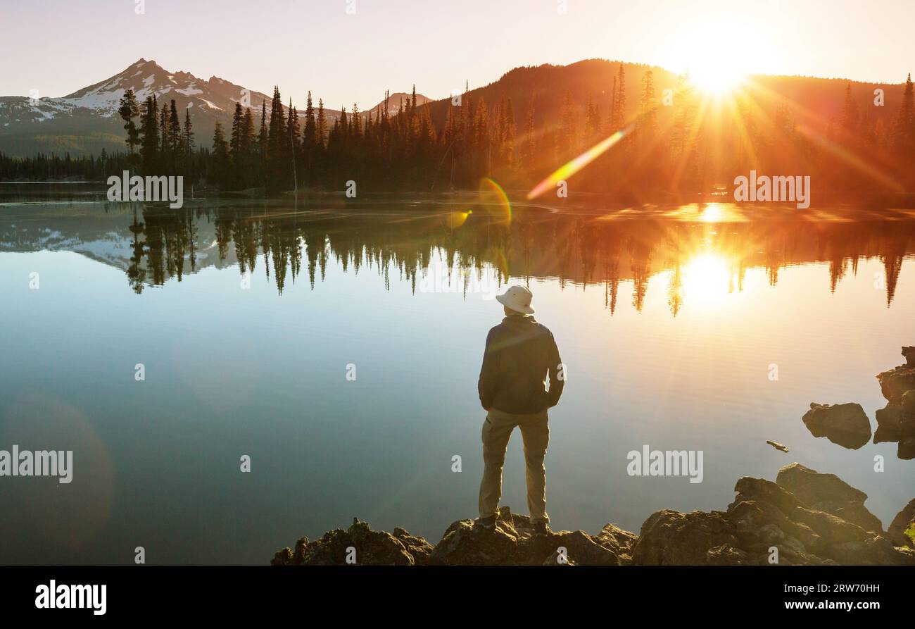 A man is resting at ease by the calm lake. Relaxation vacation Stock ...