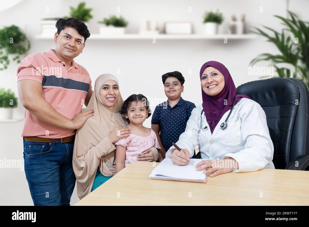 Portrait of muslim female doctor consulting young couple patients with ...