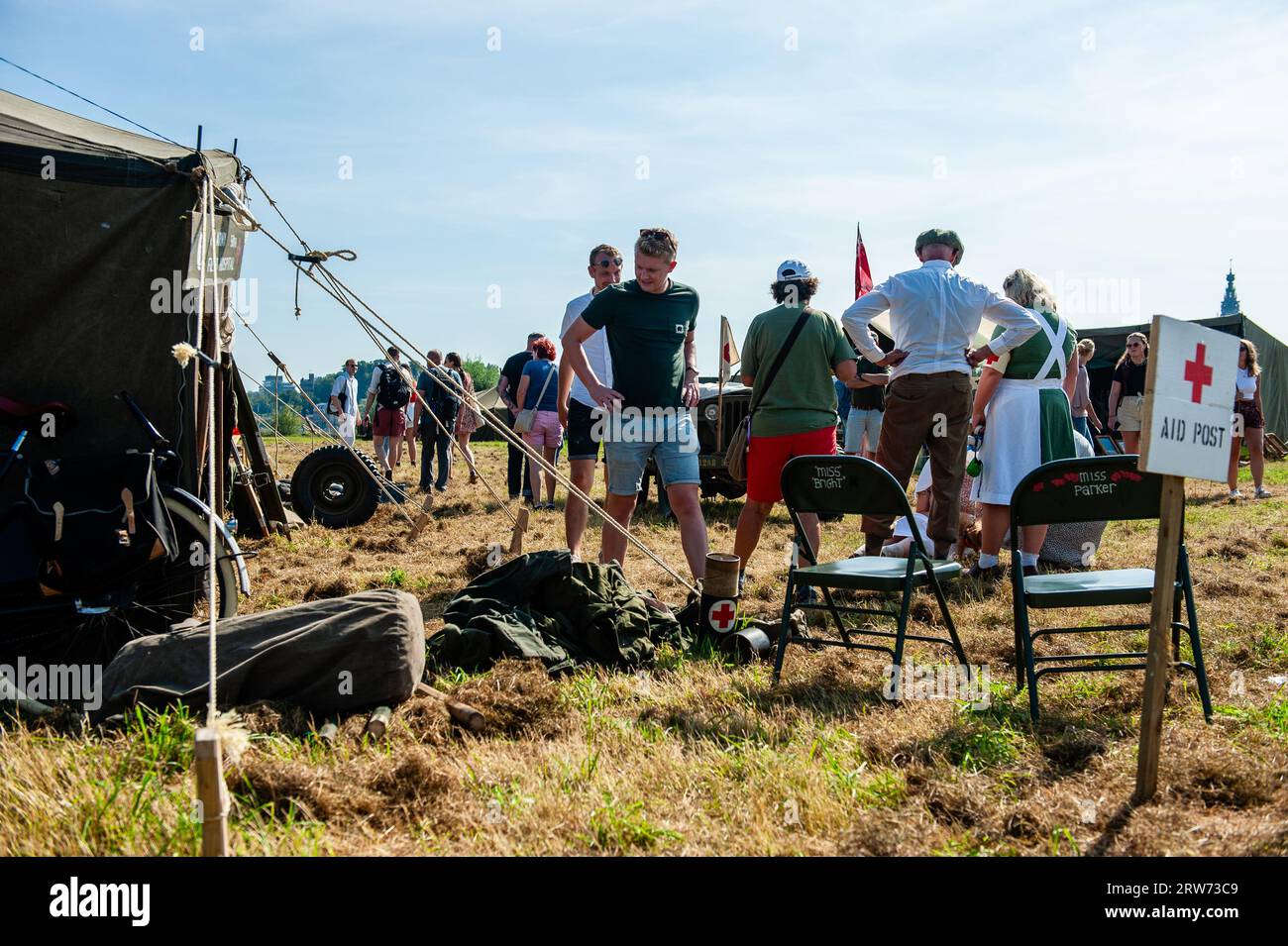 People are seen walking around a red cross war tent. This month it will ...