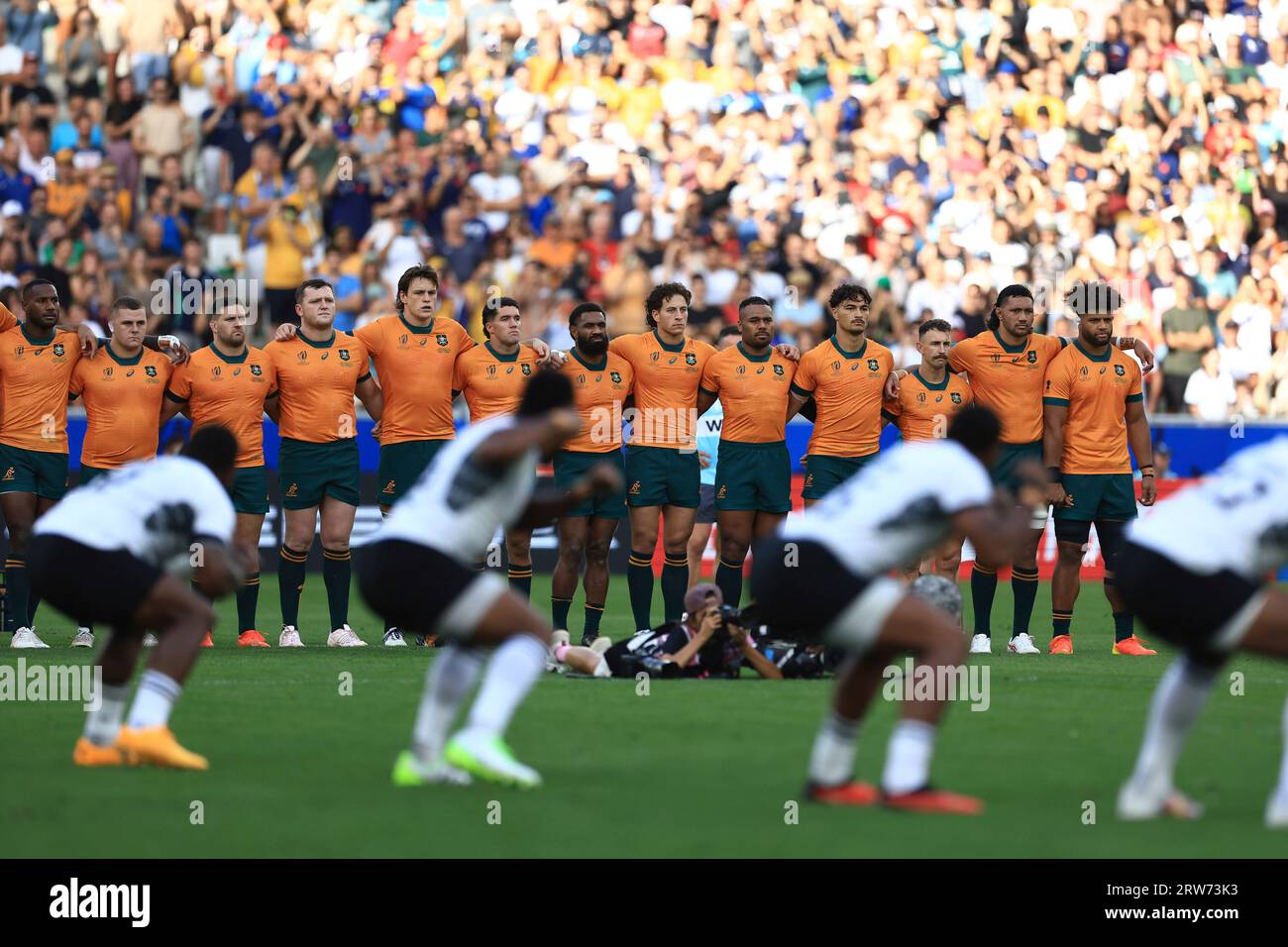 Australia's players stand as Fiji players perform a Haka before the ...