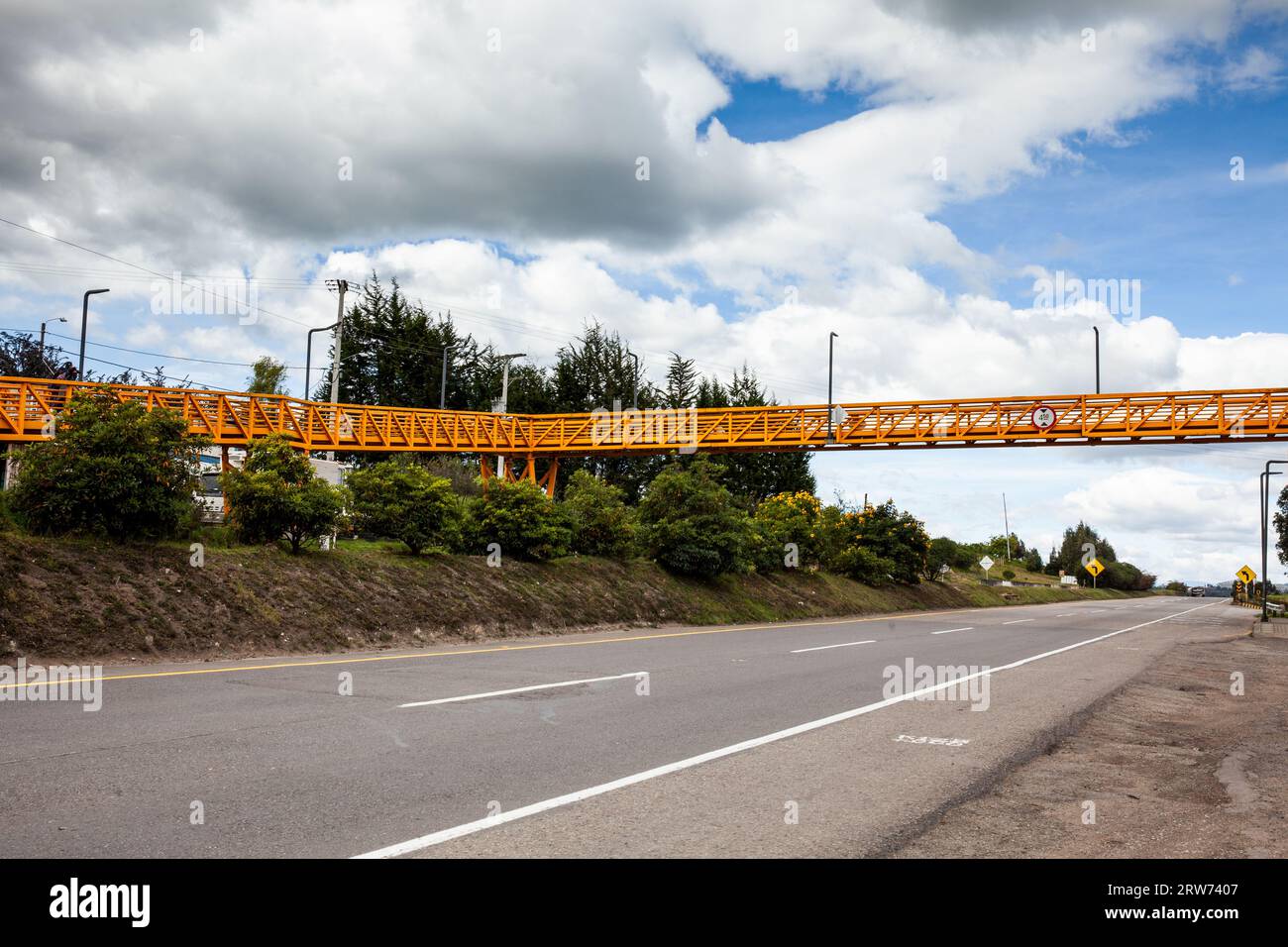 Pedestrian bridge over a high-speed road with heavy traffic. Road ...