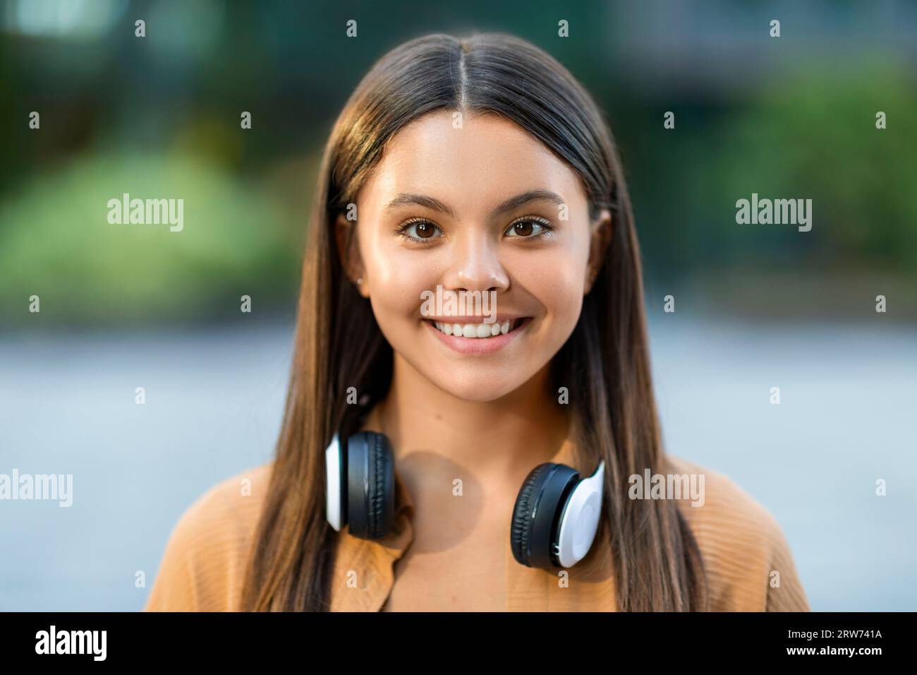 Portrait of cheerful pretty young lady student posing outdoors Stock ...