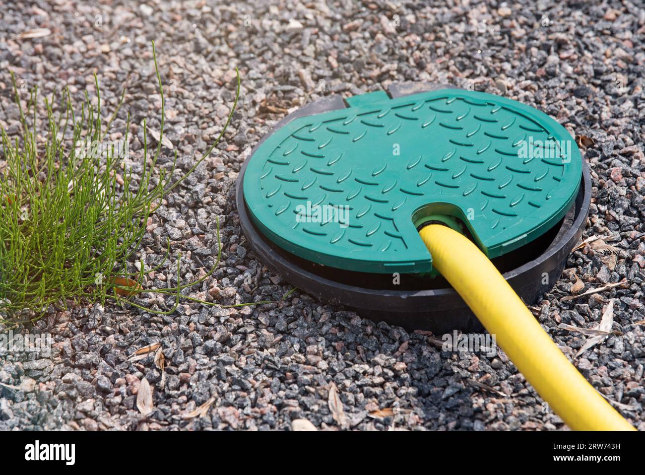 A plastic hatch in the garden covering the connection point for the ...