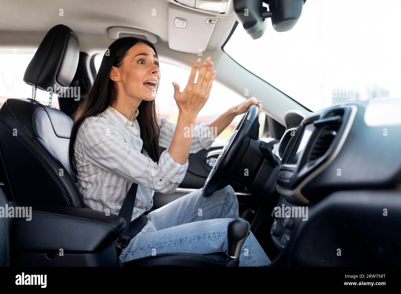 Woman driver stuck in traffic jam gesturing with hand, screaming Stock ...