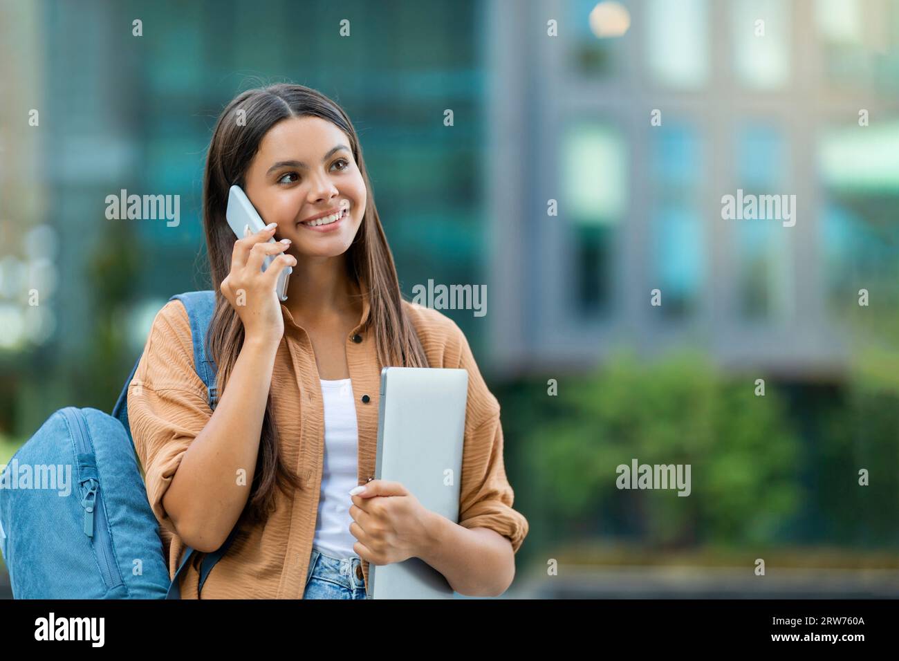 Cheerful young woman student have phone call, university campus Stock ...