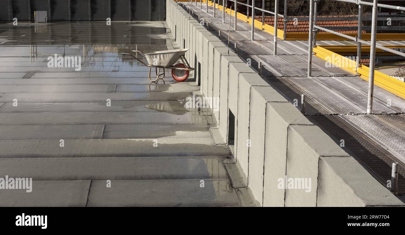 a flat roof covered with bitumen felt after rain with a wheelbarrow ...