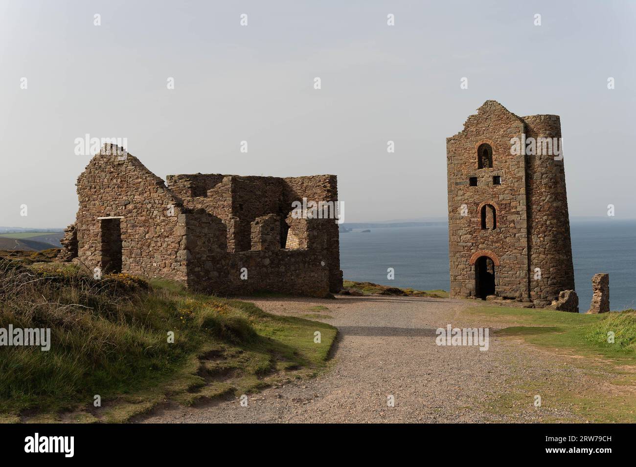 Ruined Cornish tin mine engine house overlooking the sea on clifftop ...