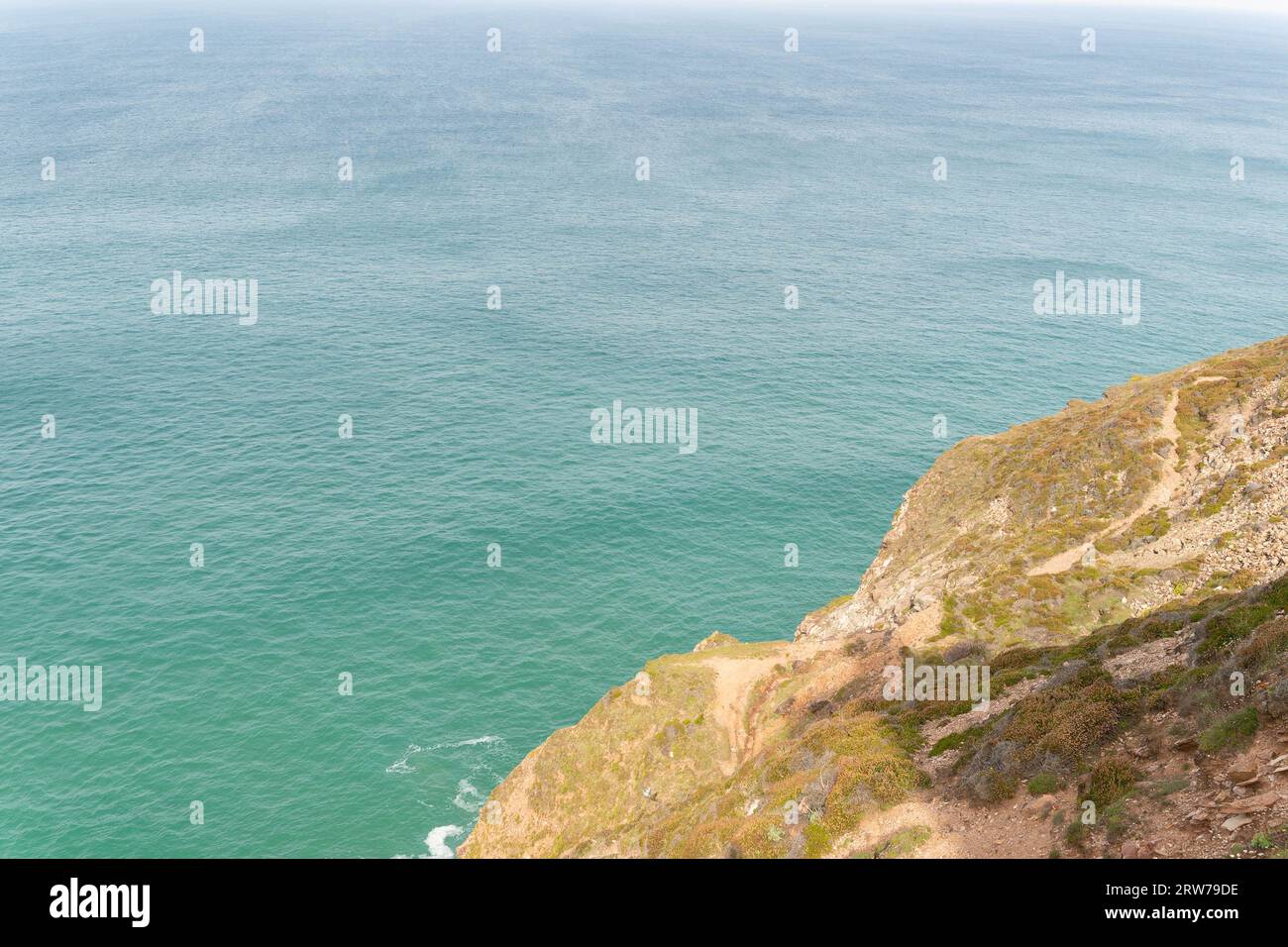 Dramatic clifftop coastal path overlooking turquoise sea waters in ...