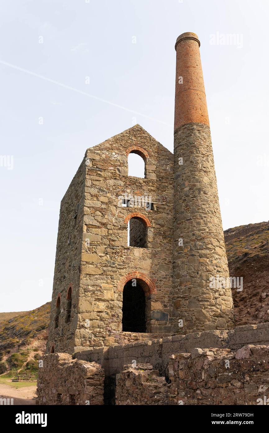 Historic Cornish tin mine engine house with tall brick chimney stack ...