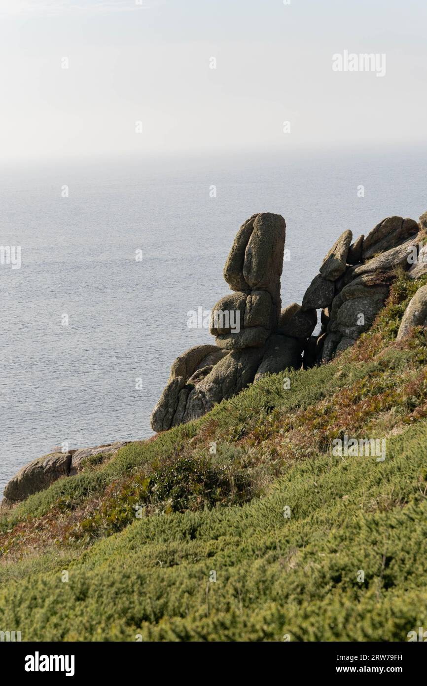 Dramatic granite rock formations on Cornish clifftop overlooking misty ...