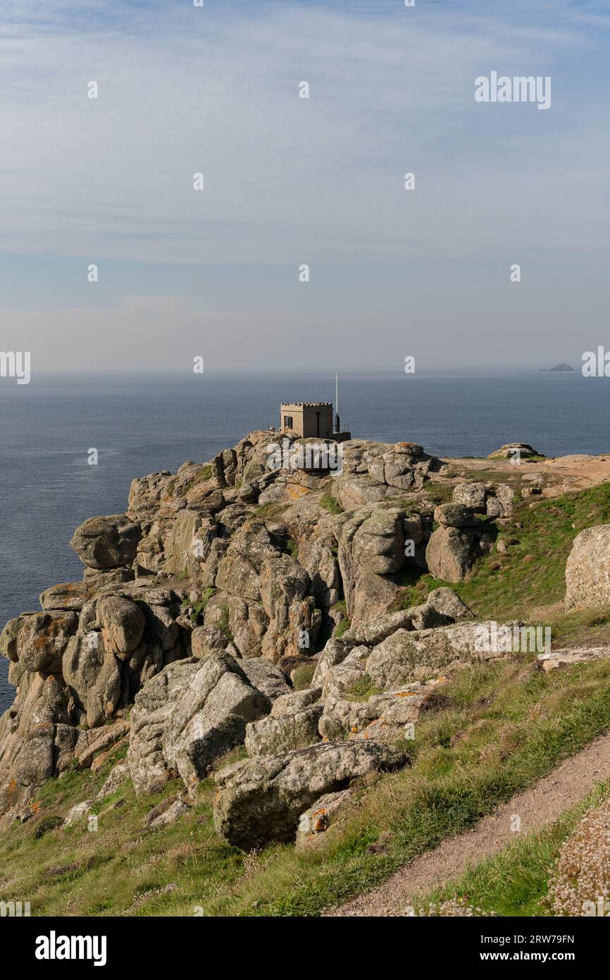 Historic coastal watchtower perched on dramatic granite cliffs ...