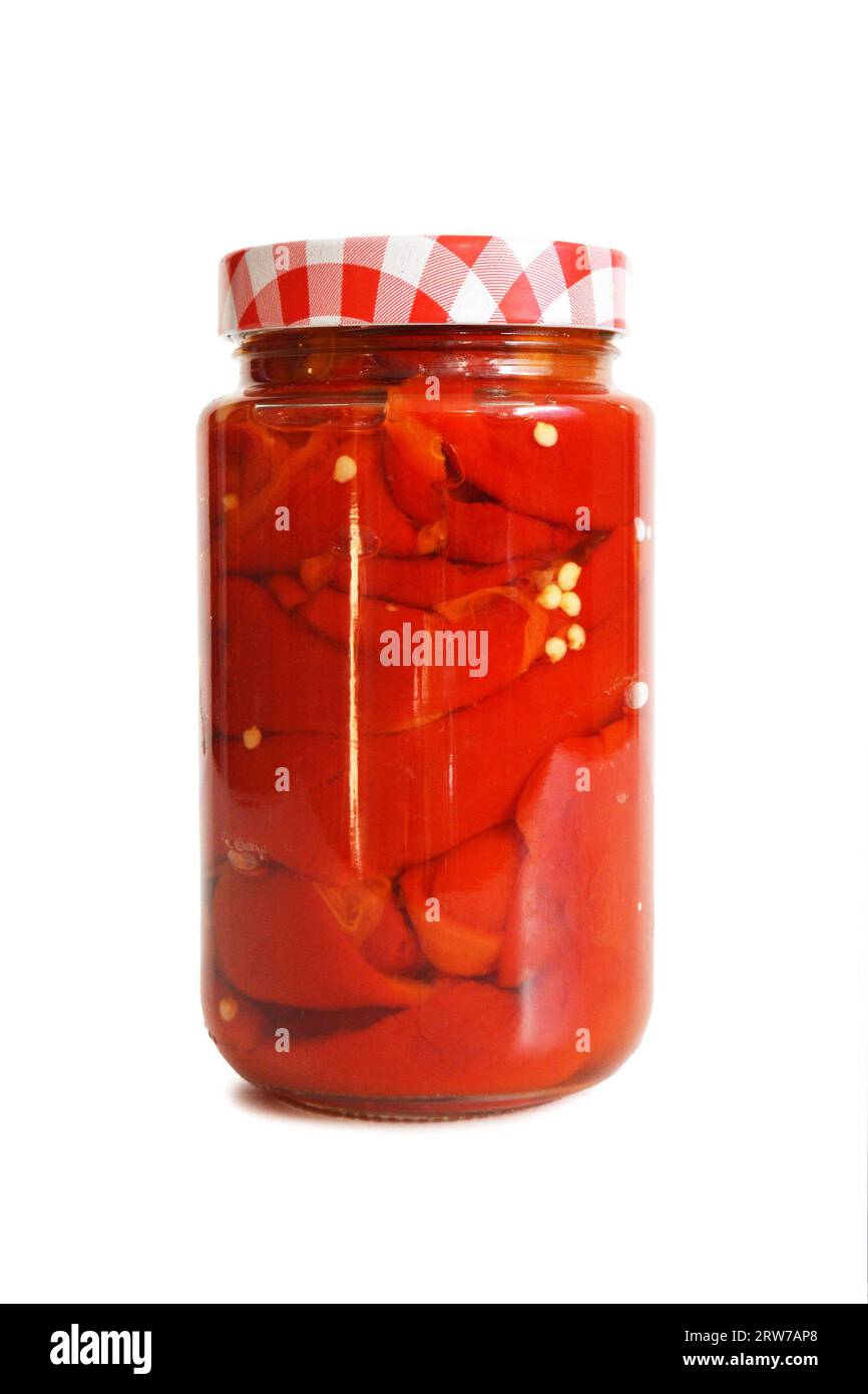 Preserved red peppers in jar isolated on white background. Fall home ...
