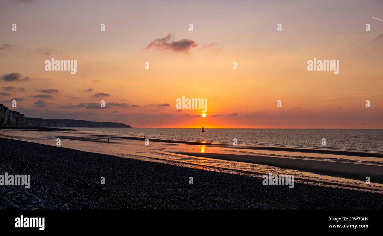 Beautiful sunset on Dieppe beach and seafront as a yacht sails past ...