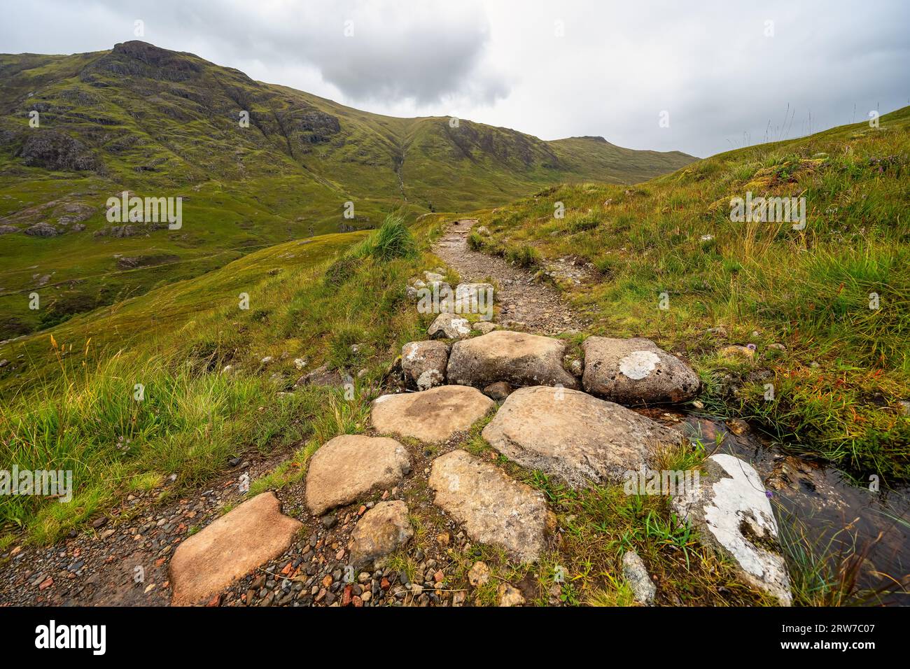 Stone path for walkers that climbs to the summit of the foggy mountain ...