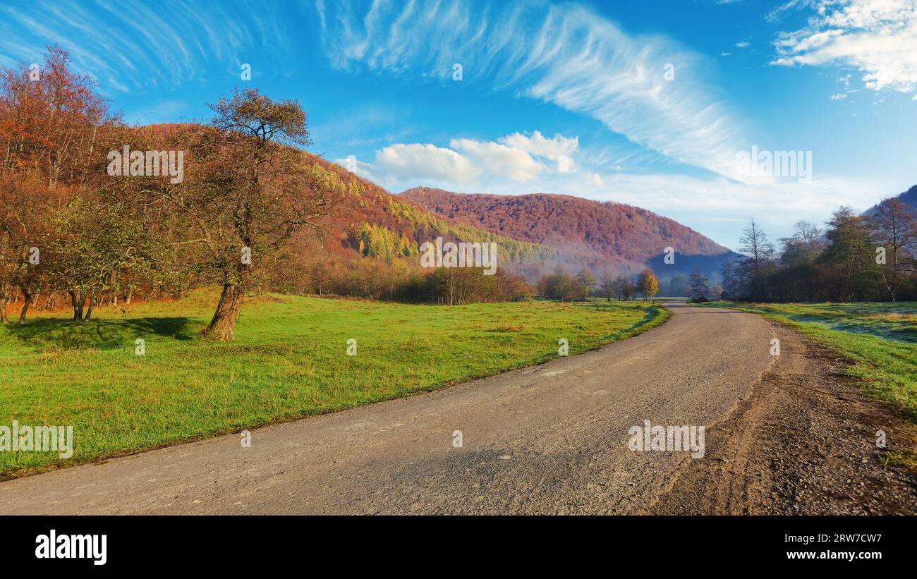 journey via road winding through countryside valley in autumn. forested ...