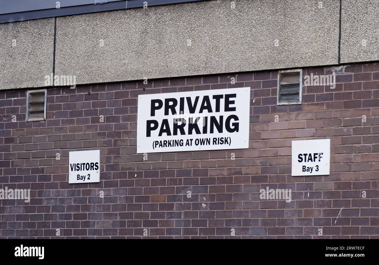 Private parking sign warning park at own risk Stock Photo - Alamy