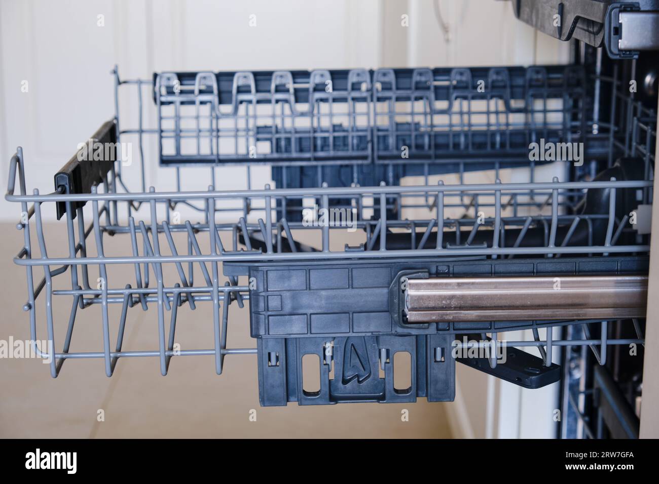 Unloading of washed dishes from the dishwasher. Empty dishwasher tray ...