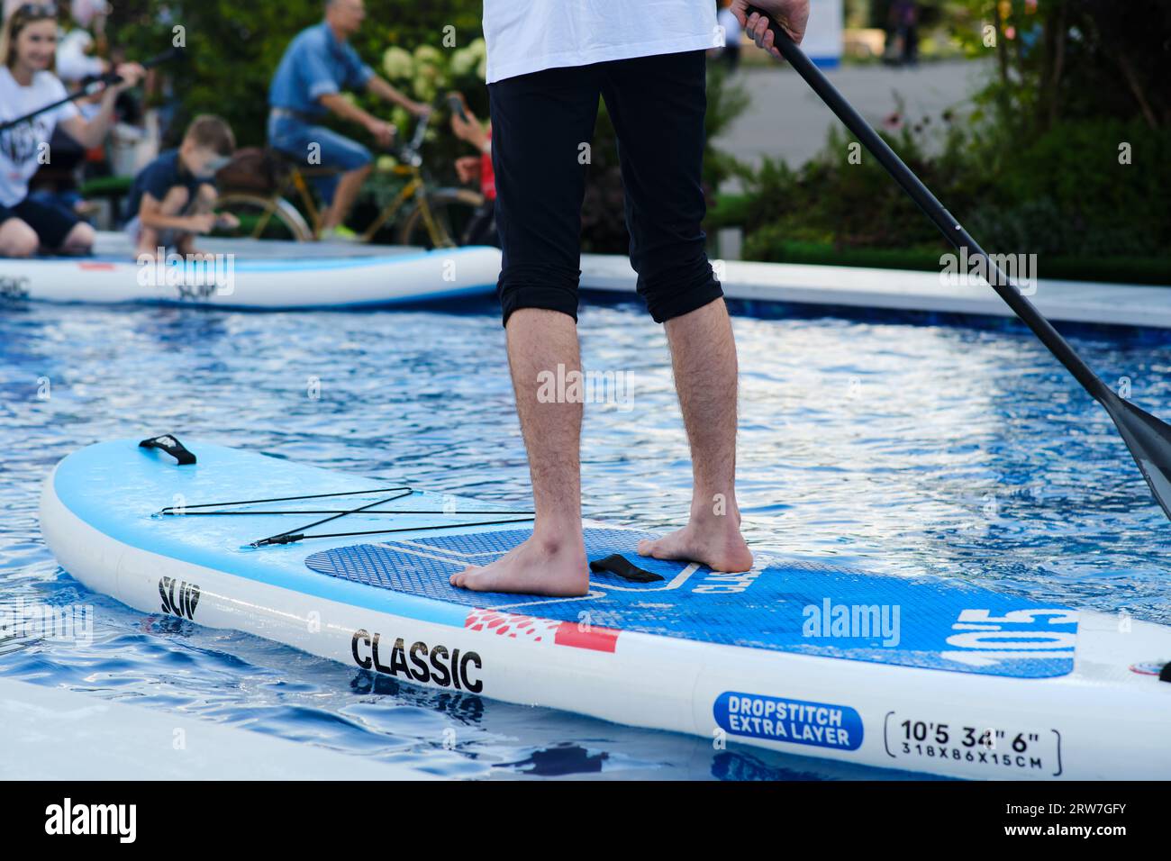 Stand up paddle board in the swimming pool with a man paddling Stock ...
