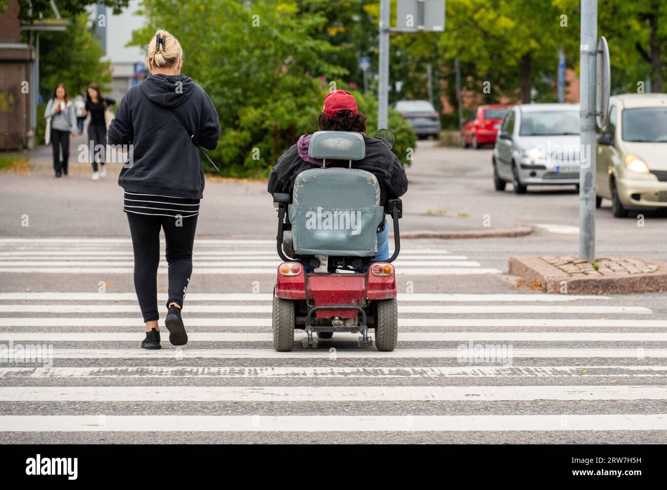 person in a electric wheelchair crossing a road Stock Photo - Alamy