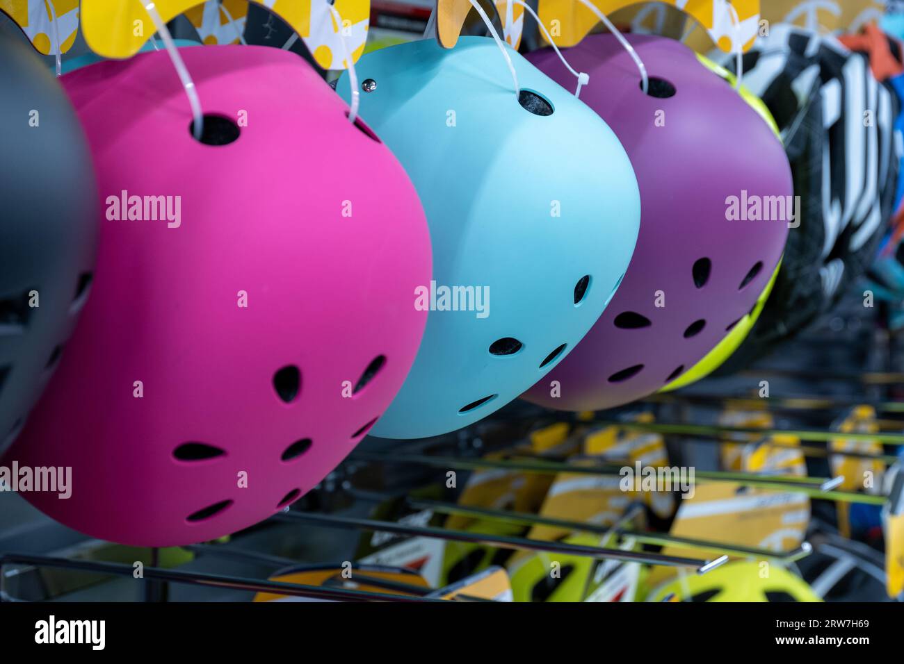 colorful bicycle helmets in supermarket shelf Stock Photo - Alamy