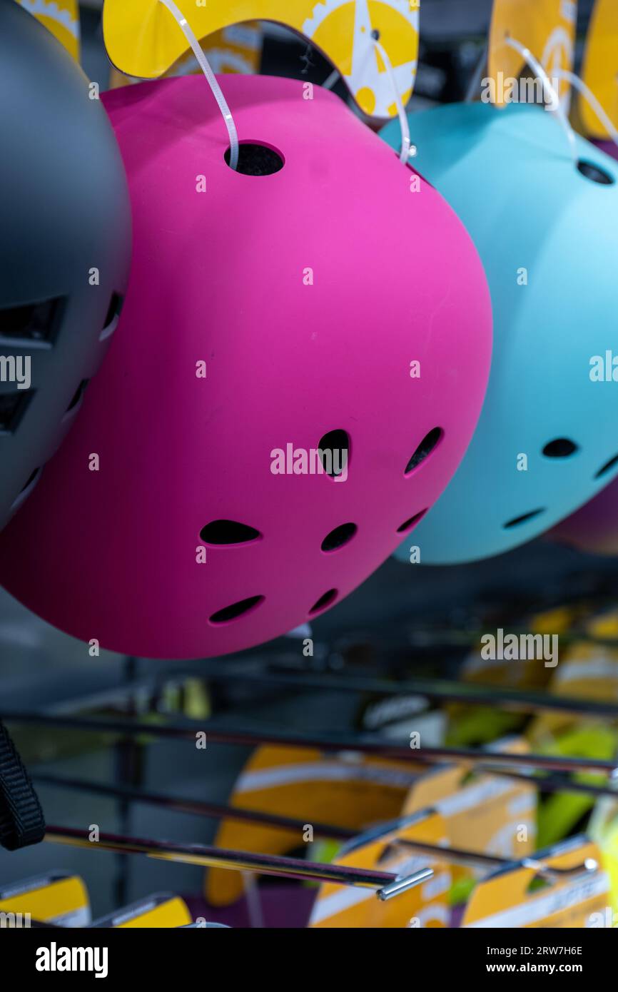 colorful bicycle helmets in supermarket shelf Stock Photo - Alamy