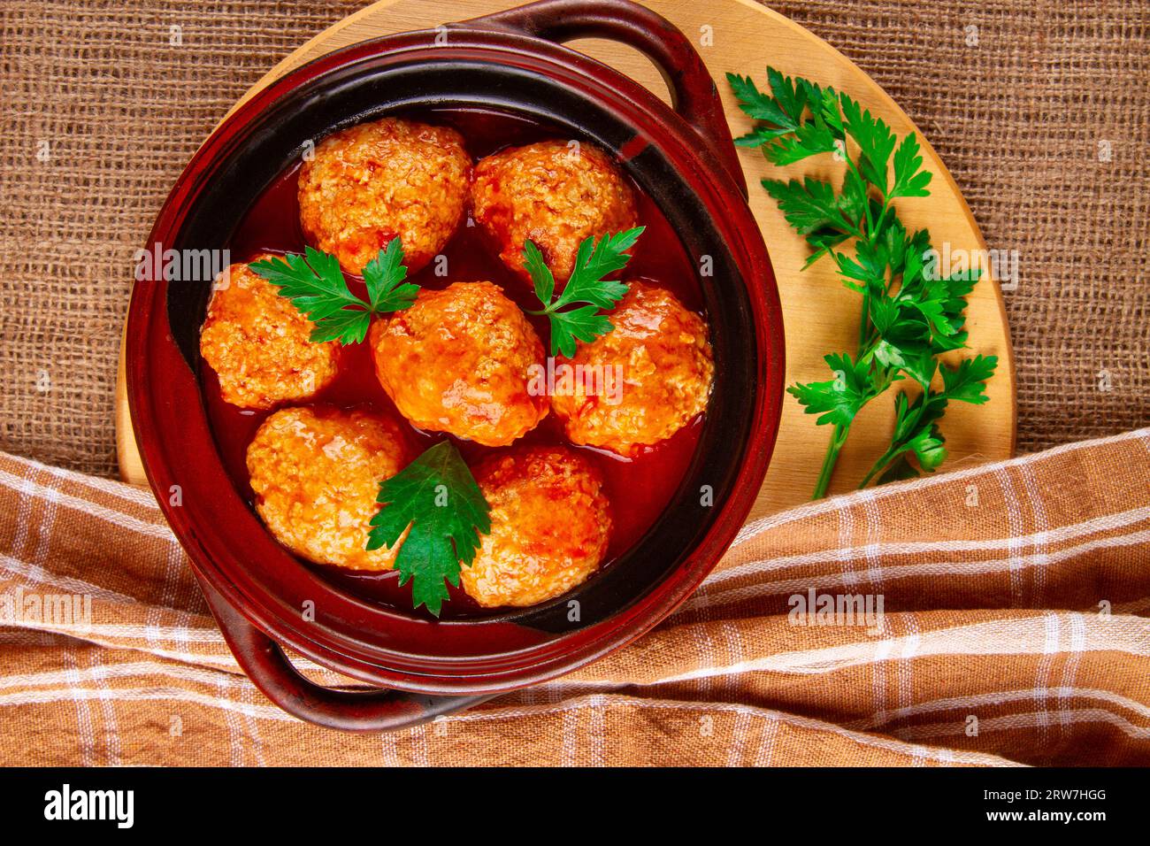 Sicilian-style meatballs in tomato sauce decorated with parsley leaves ...