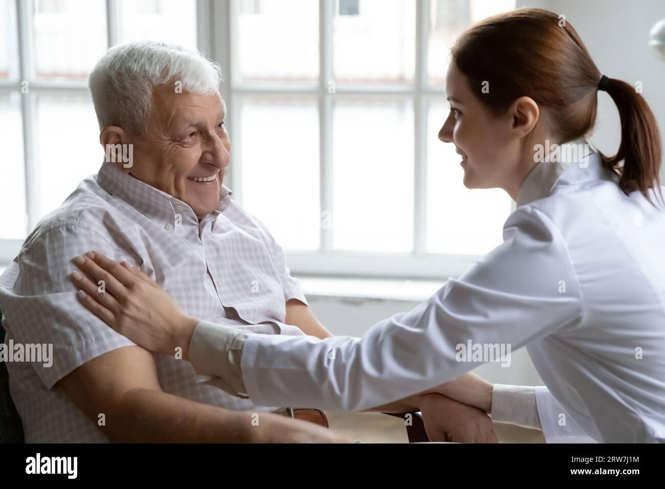 Female nurse take care of senior male patient Stock Photo - Alamy