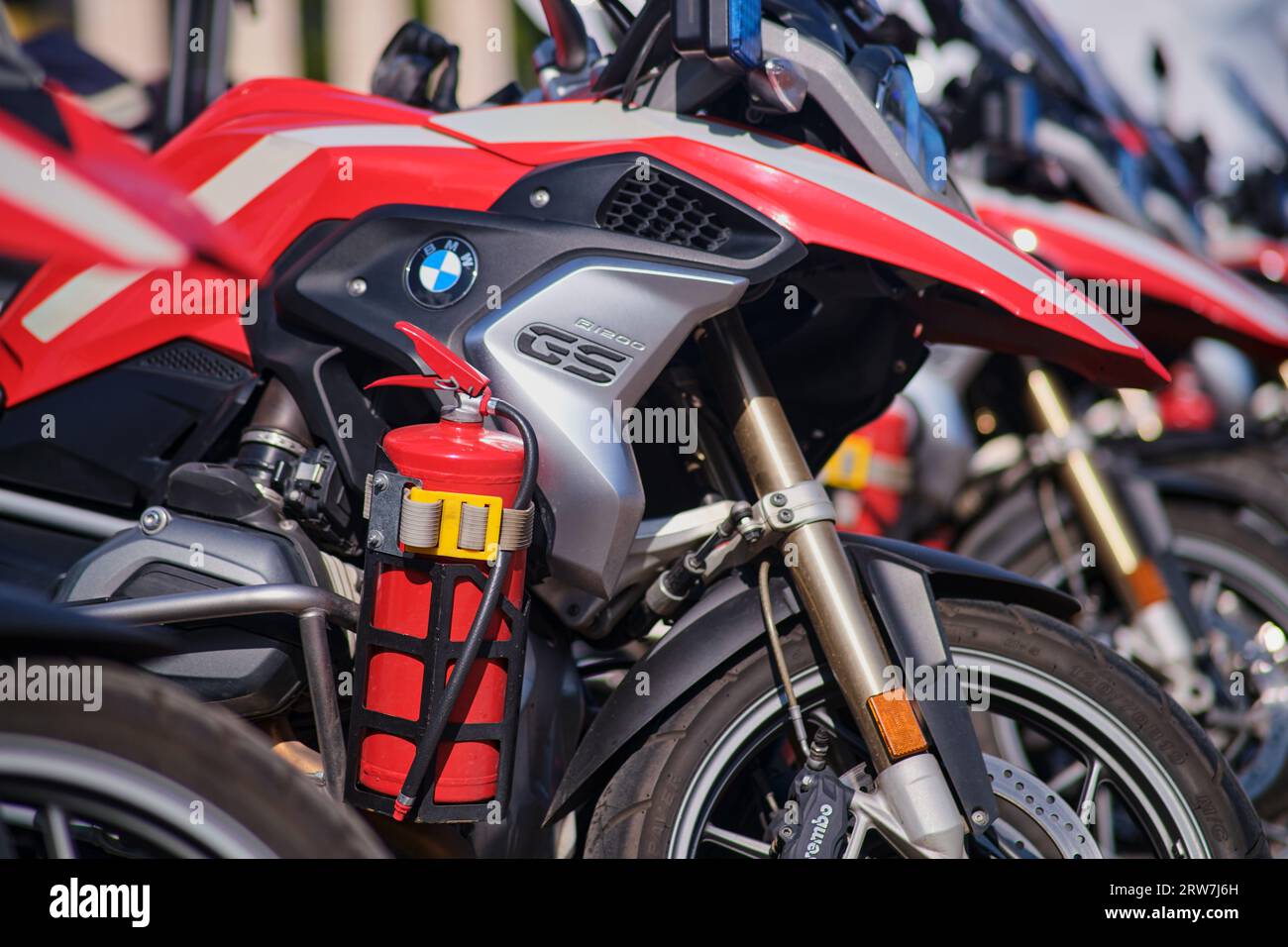Close-up of a red fire extinguisher on a fire fighting motorcycle BMW ...