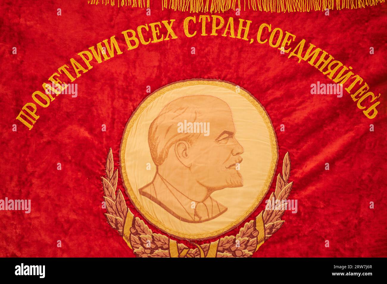 The inscription on the Soviet flag with a portrait of Lenin ...