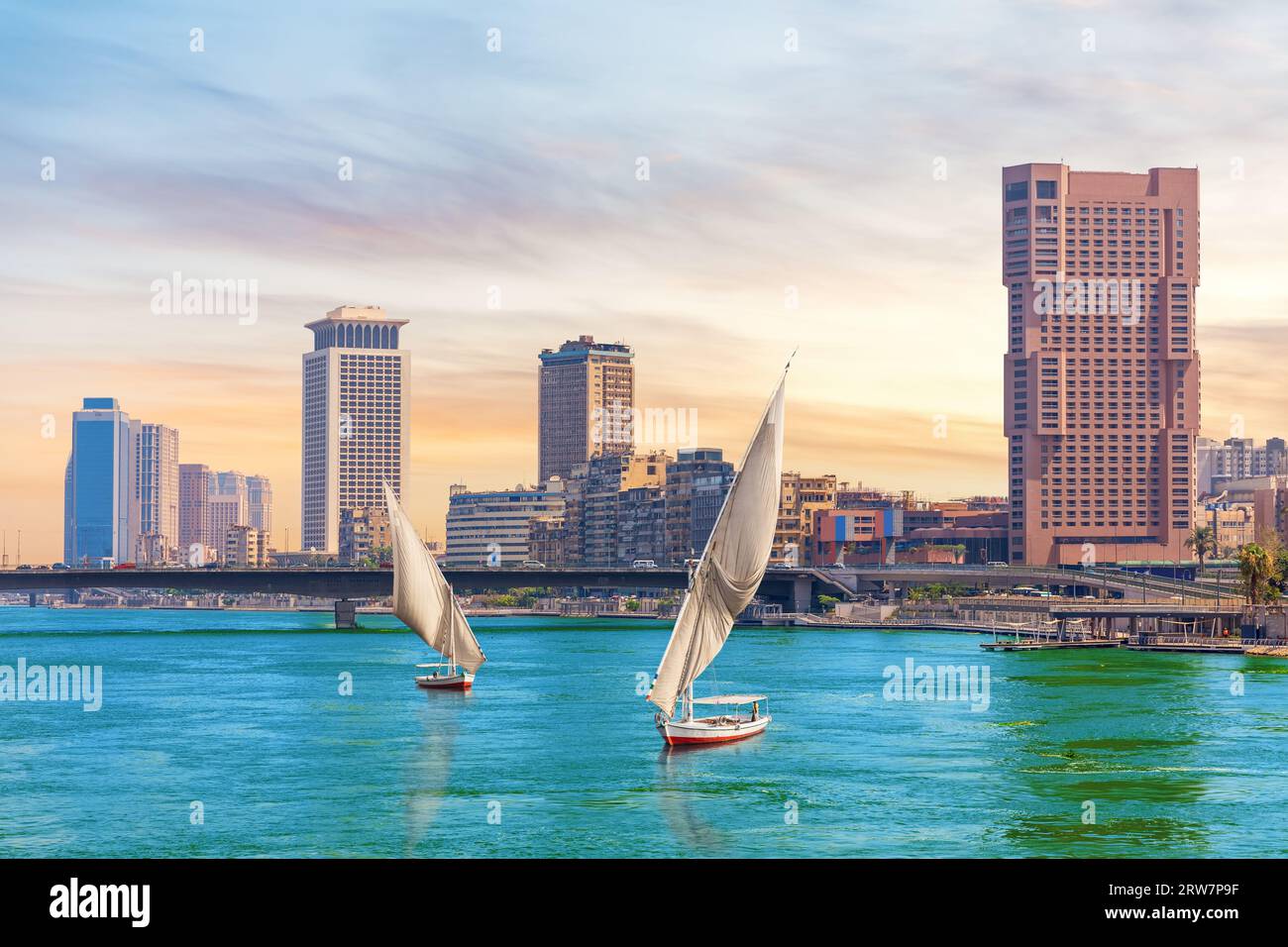 Typical boats in the Nile river and fancy buildings of Cairo, Egypt ...